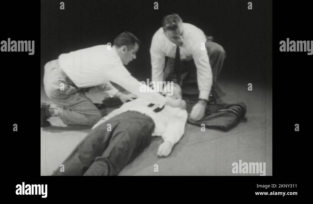 1940s: group of men lifting unconscious man onto sheet to lift Stock ...
