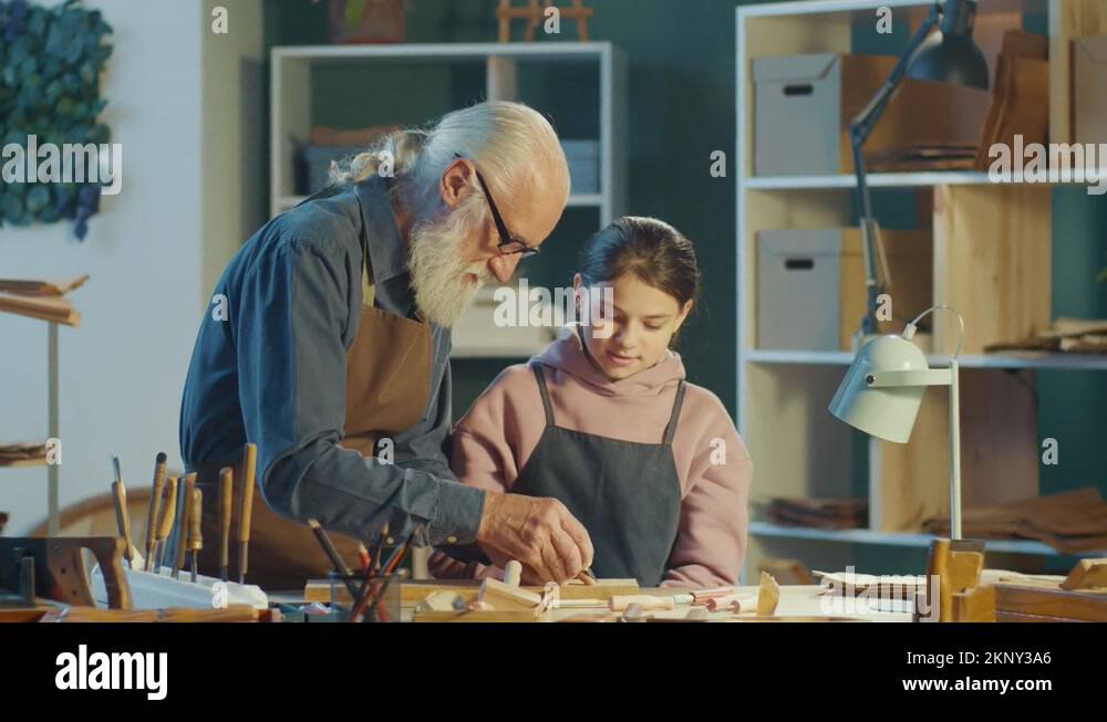 Grandfather Carpenter with his Teenage Granddaughter Works in the ...