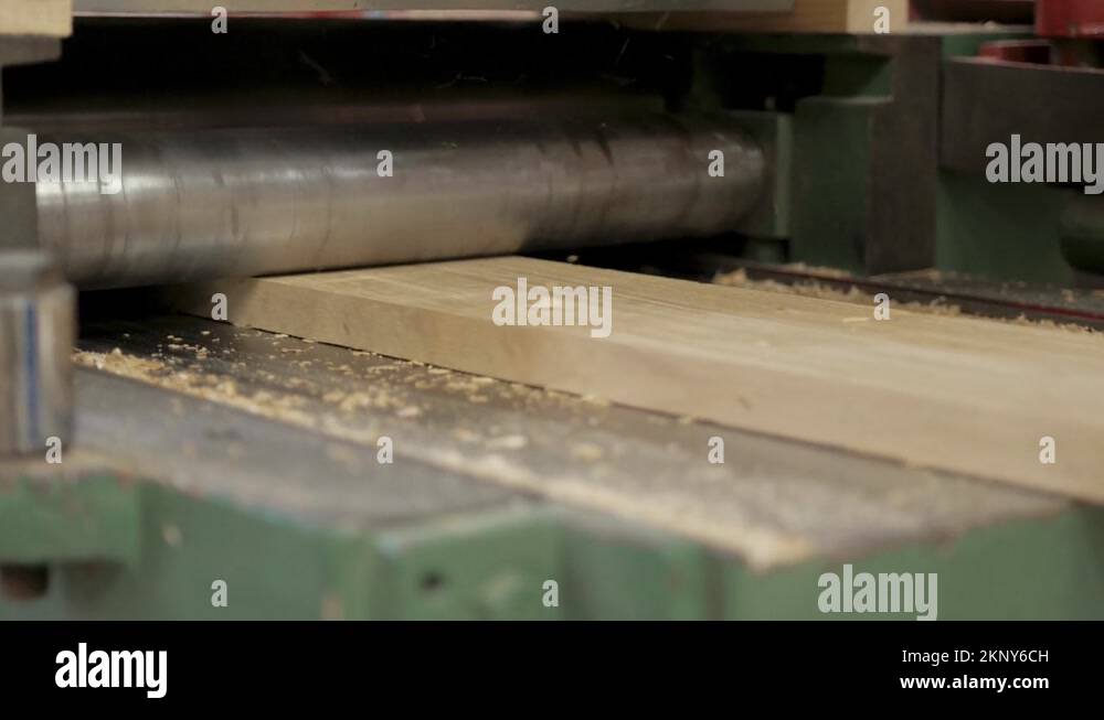 White oak hardwood plank going through planer thicknesser Stock Video ...