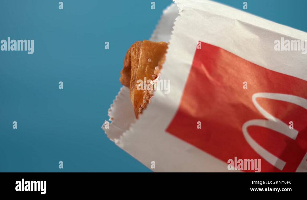 Woman takes one crispy croissant form paper package of McDonald's ...