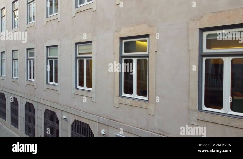 Cinematographic montage with drone: side scrolling front of building ...