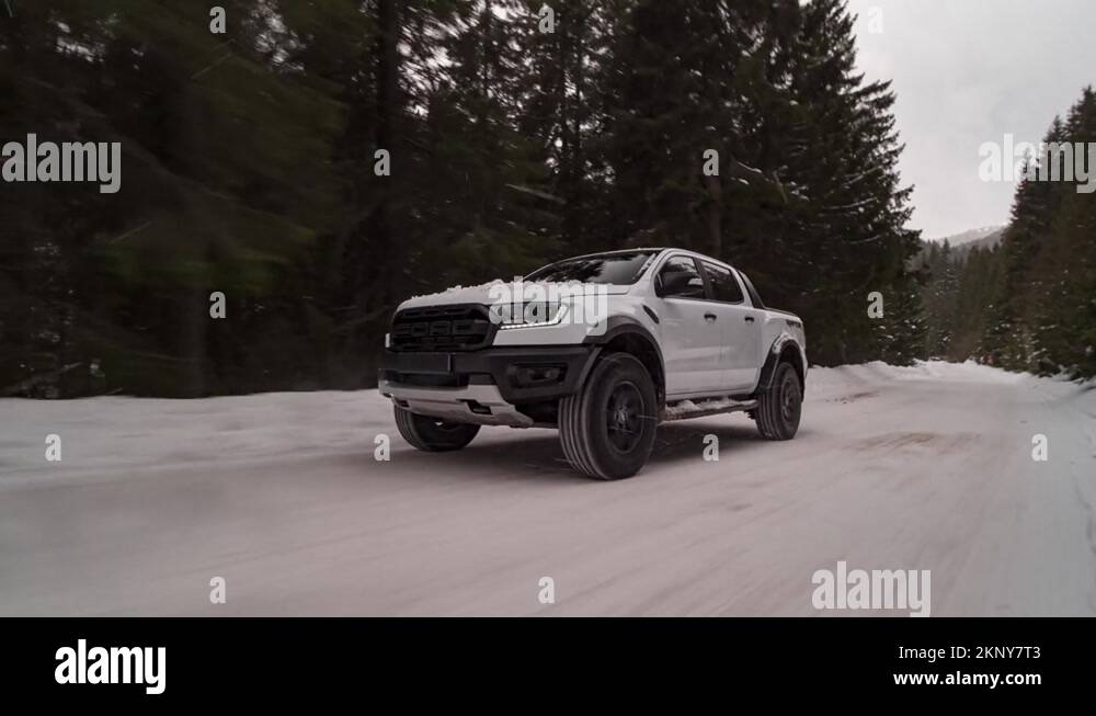 Rolling shot of Ford Ranger Raptor pickup truck car driving on mountain ...
