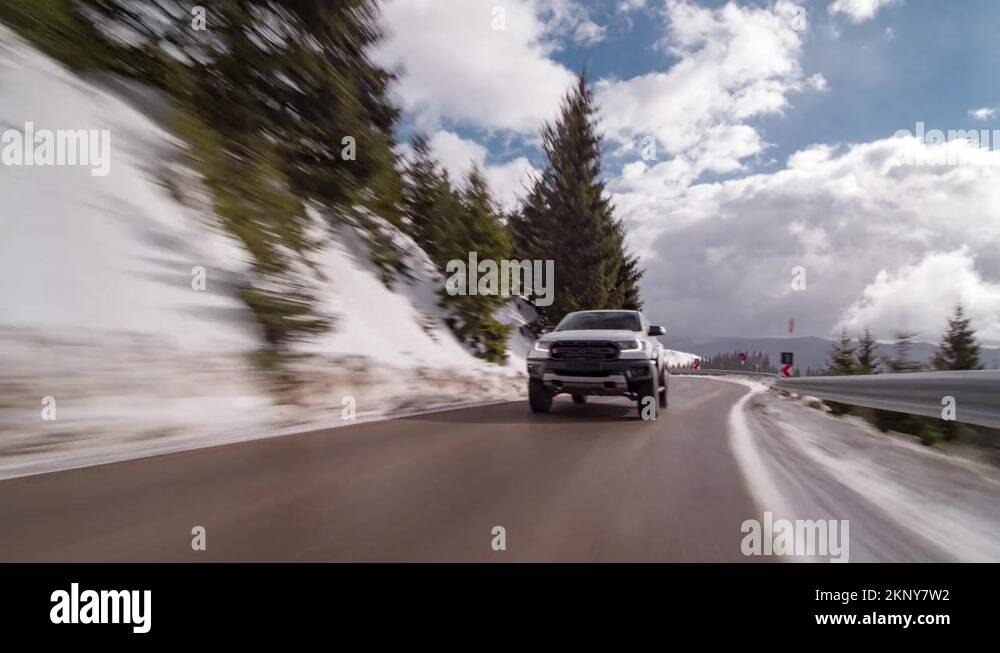 Rolling shot of Ford Ranger Raptor pickup truck car driving on mountain ...