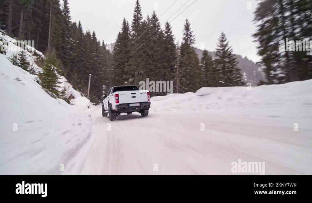Rolling shot of Ford Ranger Raptor pickup truck car driving on mountain ...