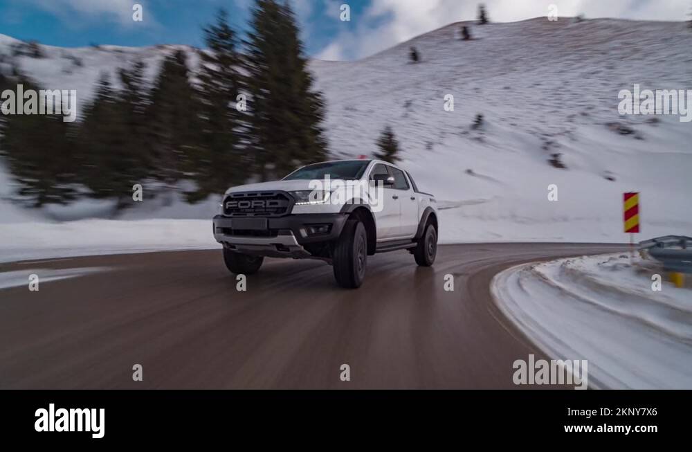 Rolling shot of Ford Ranger Raptor pickup truck car driving on mountain ...