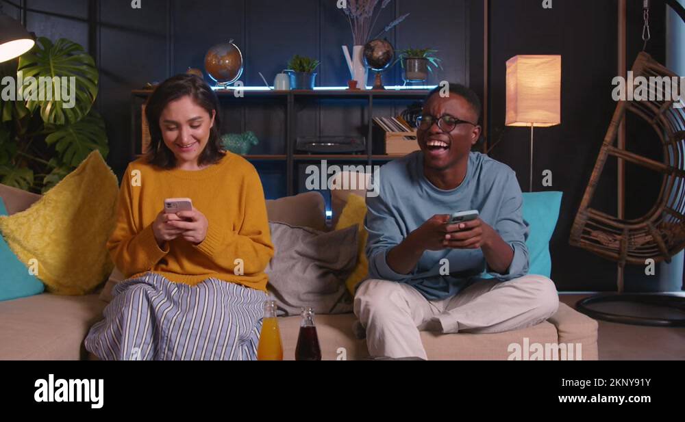Young happy multiethnic man and woman friends play games against each other Stock Video Footage ...