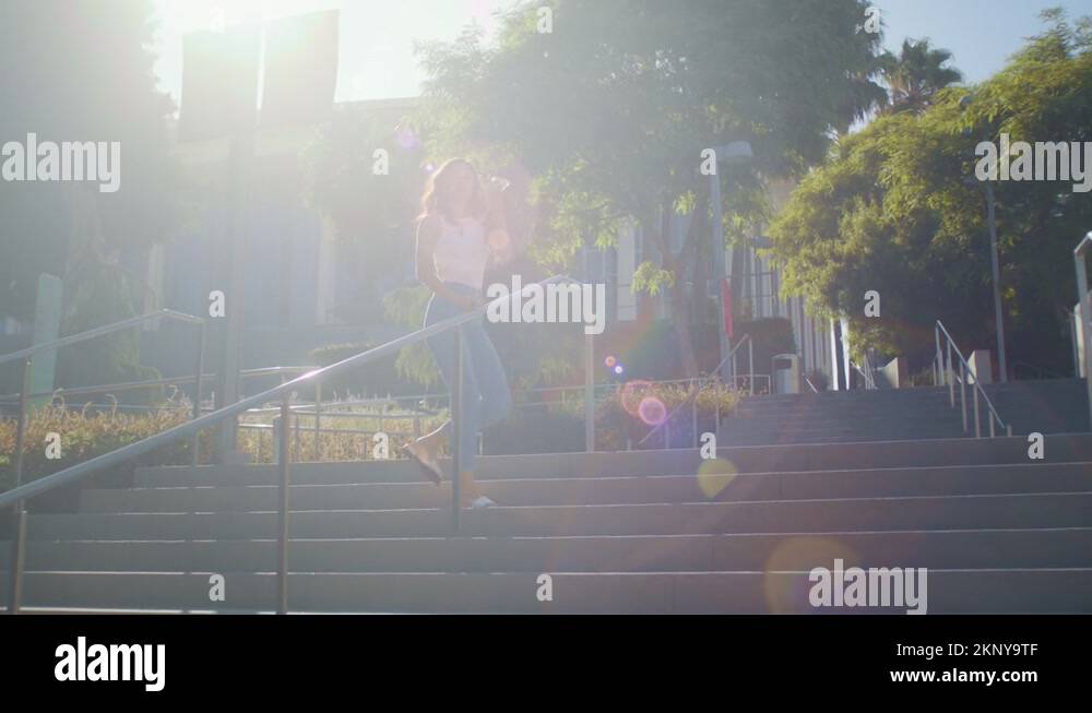 Longhair woman rush upstairs make photo. Asian girl run stairscase take ...