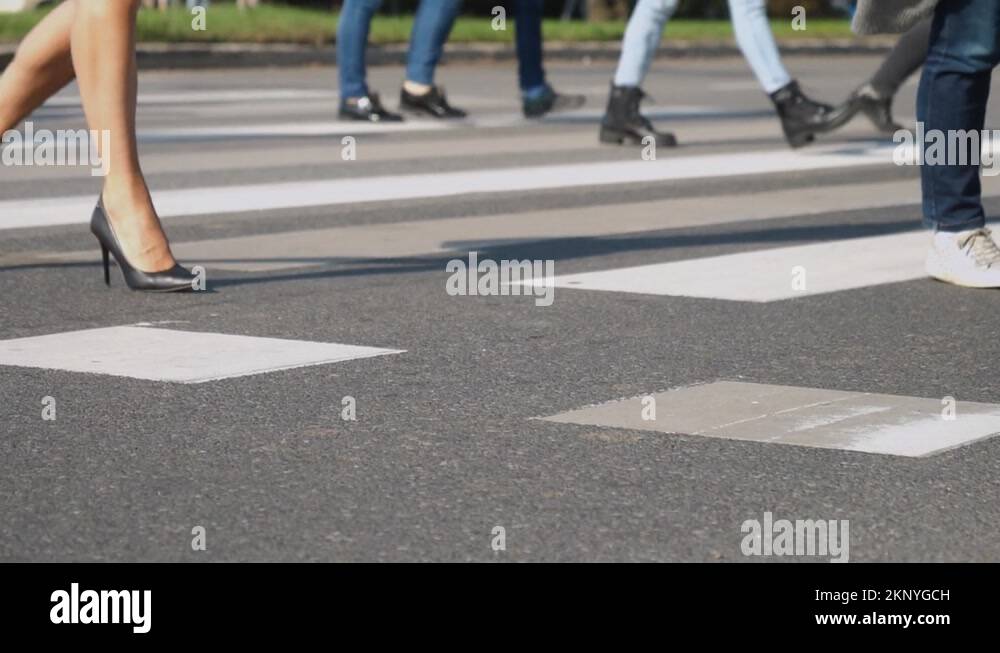 Gen Z corporate choice of footwear passing zebra crossing Stock Video ...