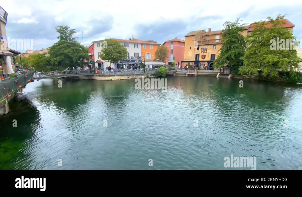 Bouïgas basin on the Sorgue river and colored buildings of l'Isle-sur ...
