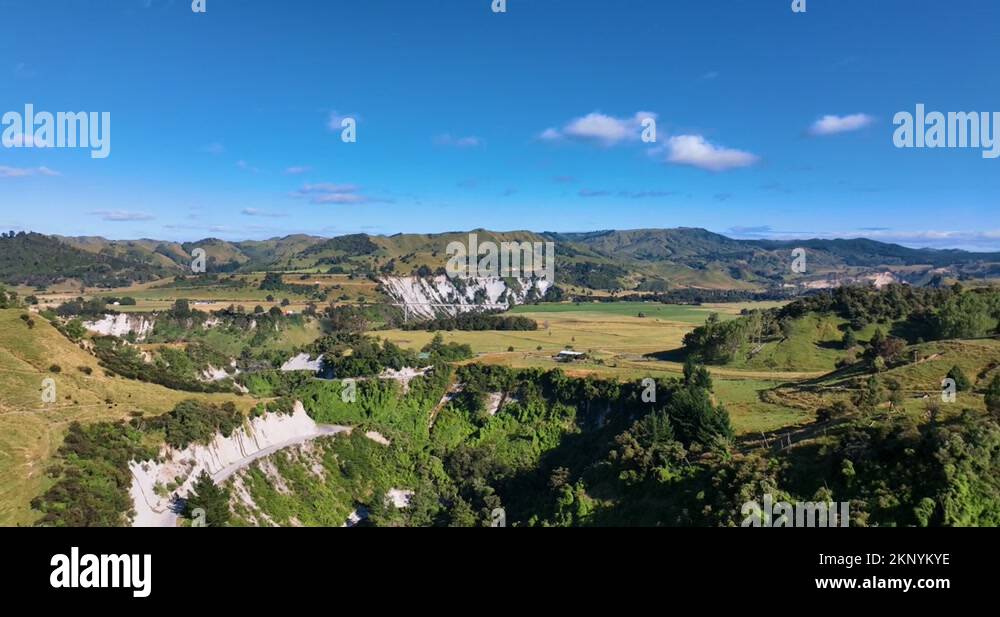Summer aerial reveals dramatic sunken valleys and steep grey clay ...