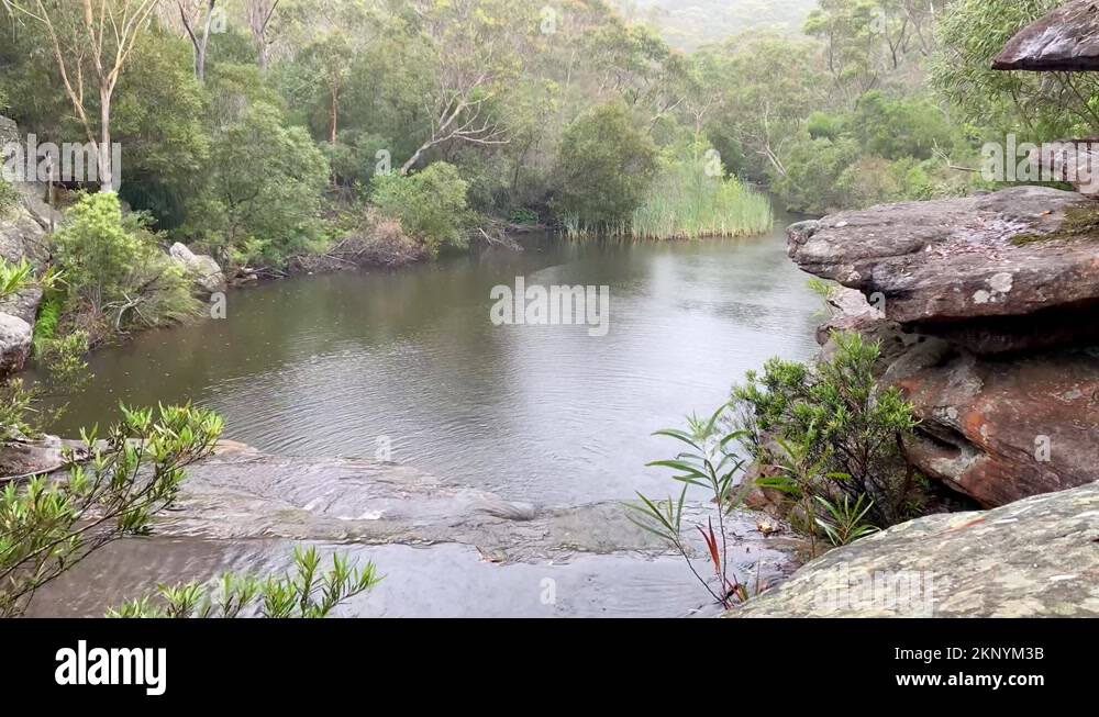 Large natural swimming hole during rain in the Australian bush Stock ...