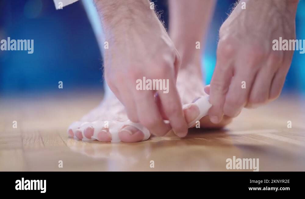 Putting on silicone medical toe corrector against hallux valgus joint ...