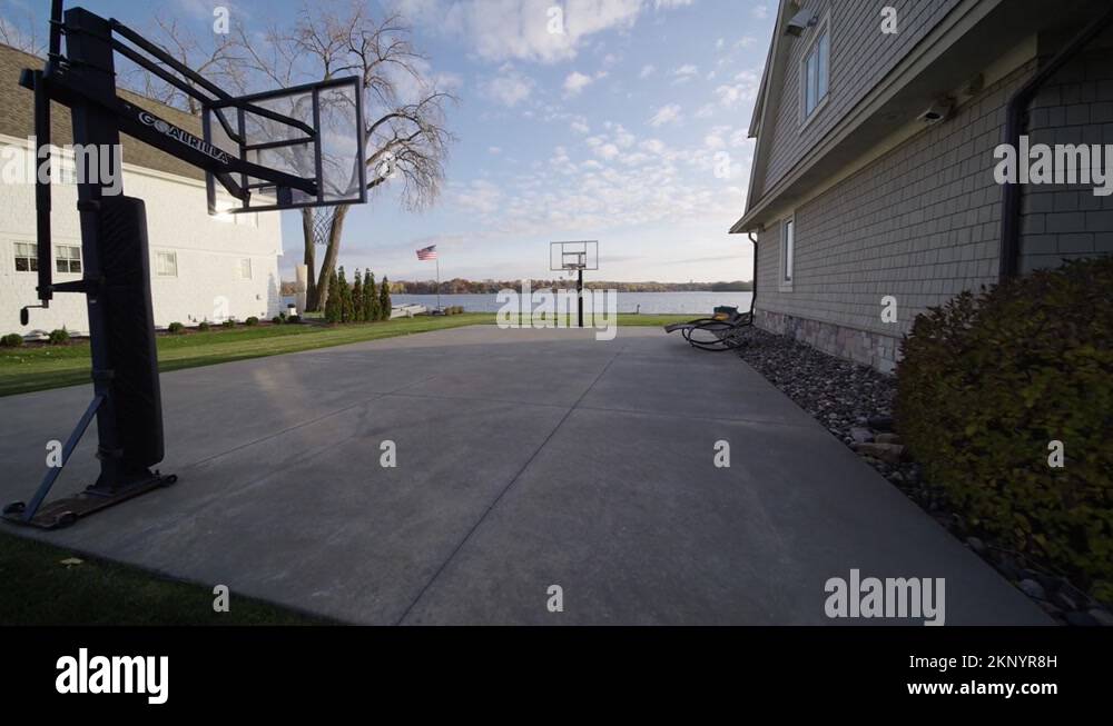 full length basketball court in the backyard of a luxury home on the ...