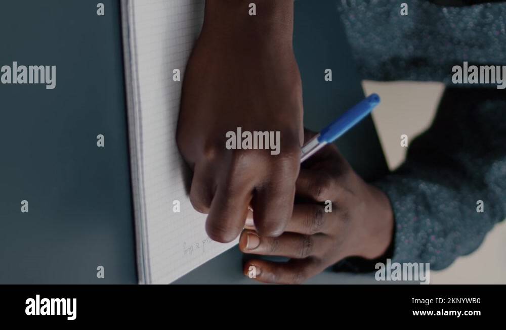 Vertical video: African american black person writing notes on notepad ...