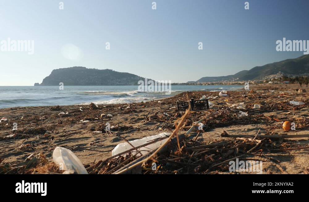 Garbage on dirty beach. Plastic waste trash on sandy beach. Pollution ...