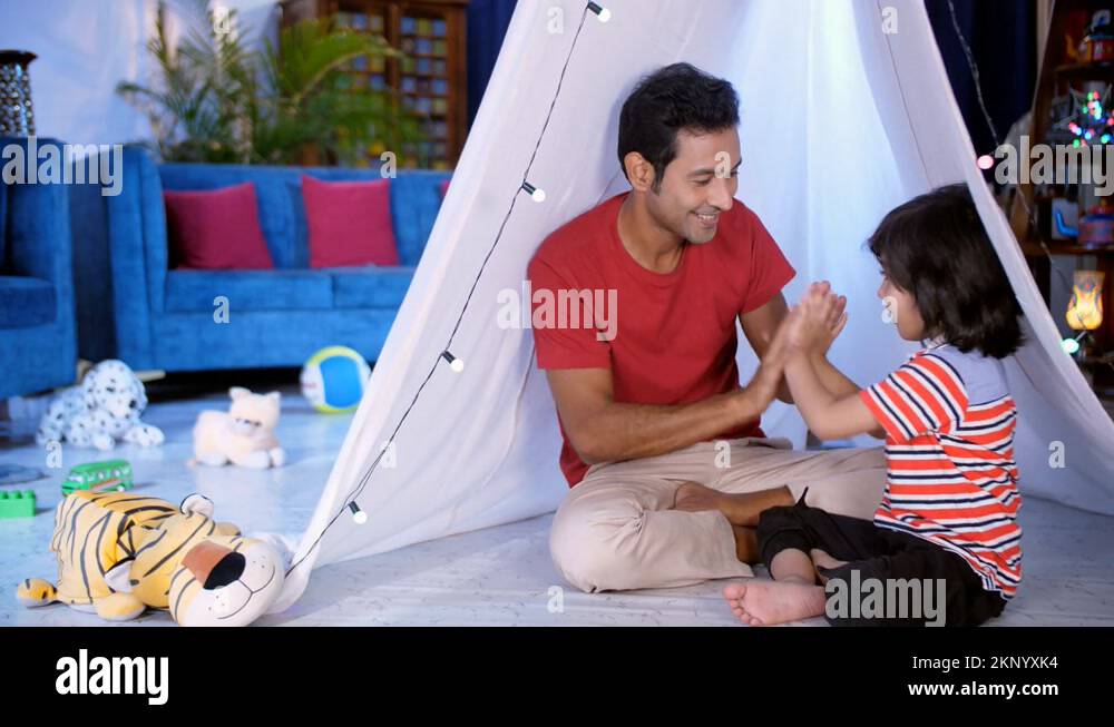 Single father and his cute son playing hand-clapping games together ...