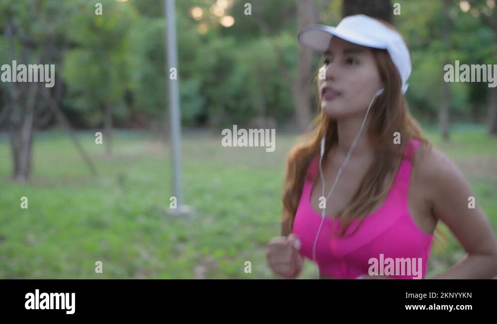 Exercise concept of 4k Resolution. Asian woman jogging in the park ...