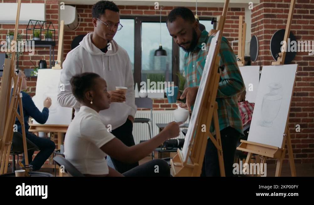 Team of students talking about drawing inspiration in art class Stock ...