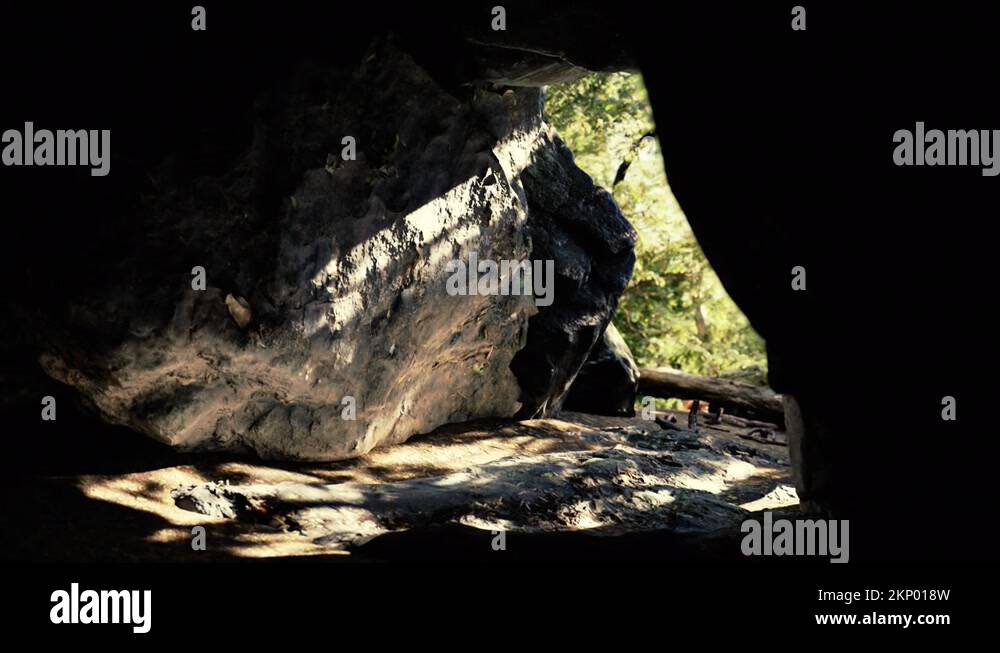 shot taken from inside a small cave looking out Stock Video Footage - Alamy