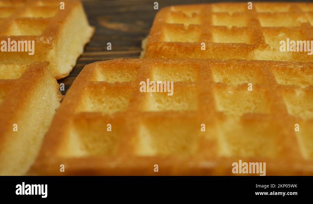 pastry chef removes purple silicone mold from baked Belgian waffles ...