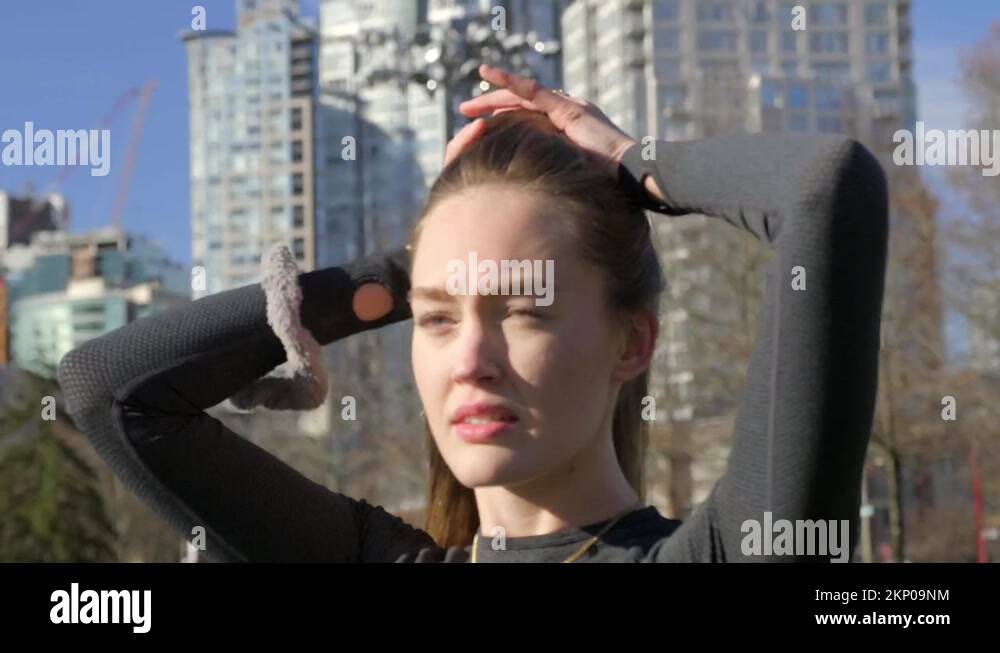 Beautiful Athletic Young Girl Tying Up Hair Before Running In City Stock Video Footage Alamy