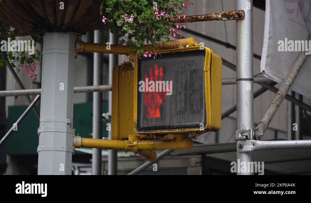 Red Hand Pedestrian Crosswalk sign in New York City on a cloudy rainy ...