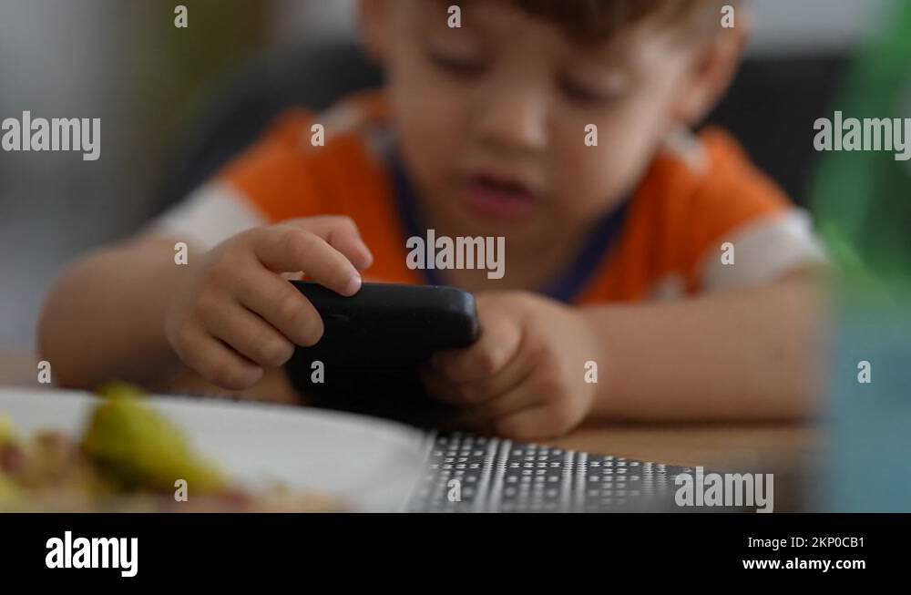 Child using phone kid touching screen with finger little boy uses ...