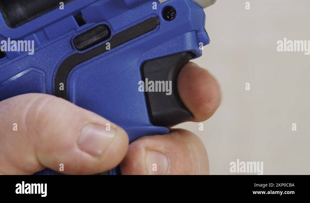 Closeup finger of person pulling trigger of screwdriver, side view ...