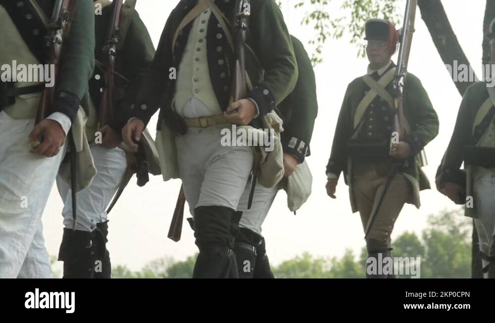 Uniformed Rev War Re-enactor Soldiers Marching with flintlocks Stock ...