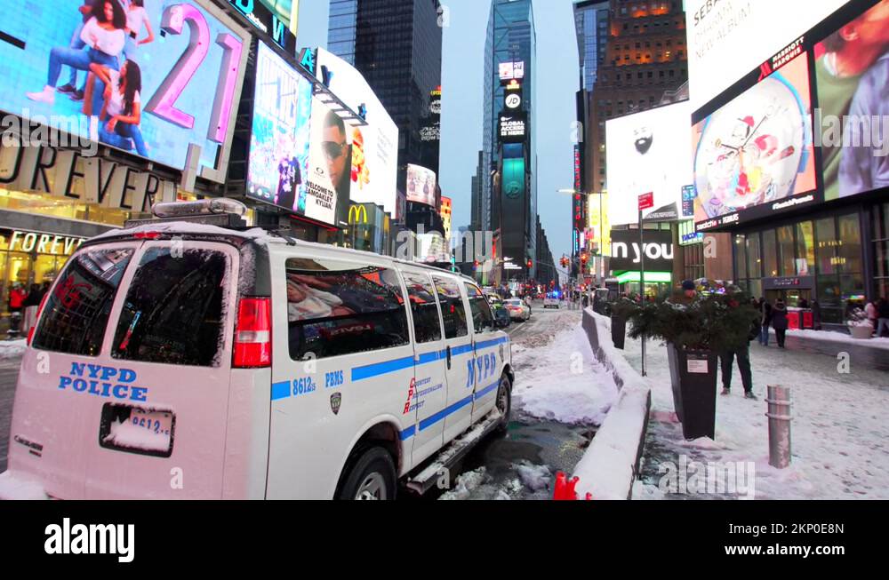 NYPD Police car at Times Square covered with snow. Skyscrapers and ...
