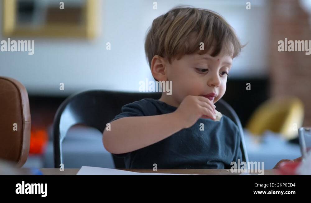 One little boy eating bread at home child eats carb food Stock Video ...