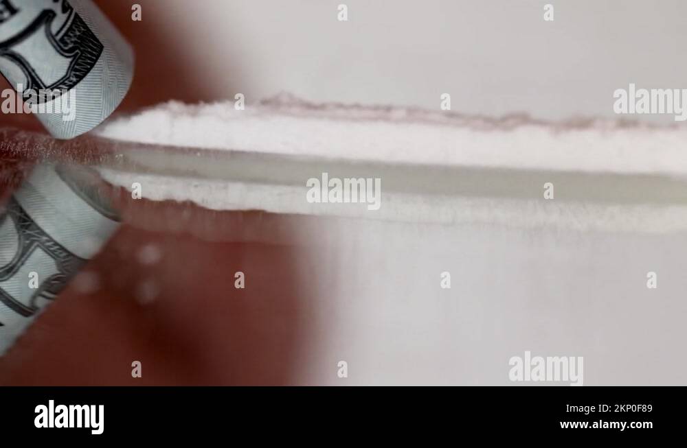 Cocaine junkie snorting line of coke with rolled US dollar bill Stock ...