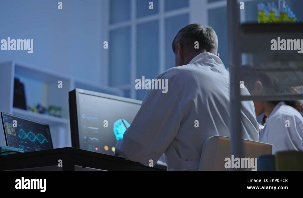 Team of medical laboratory scientists studying brain mri on computer ...