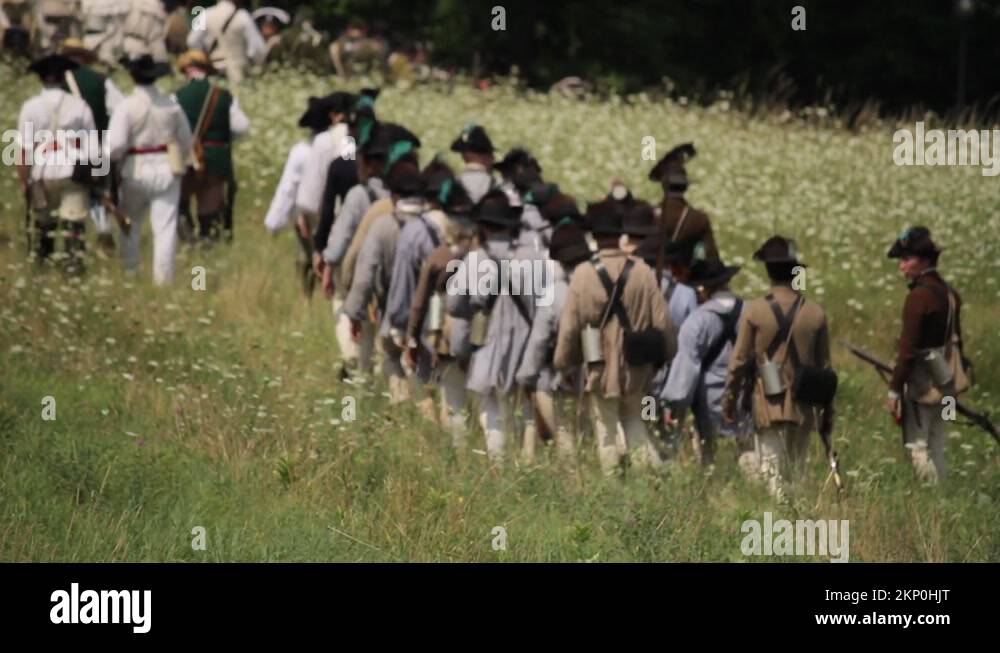 Uniformed Rev War Re-enactor Soldiers Marching with flintlocks Stock ...