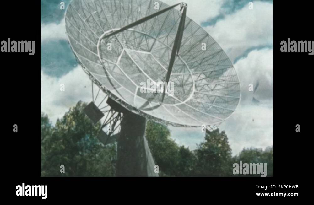 1950s: Tilt up satellite dish. Lines on film, hand points to lines with ...