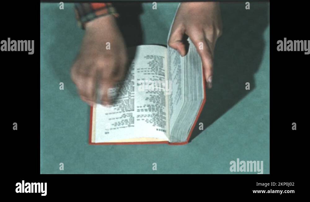 1950s: Hands open book, crease pages along spine Stock Video Footage ...