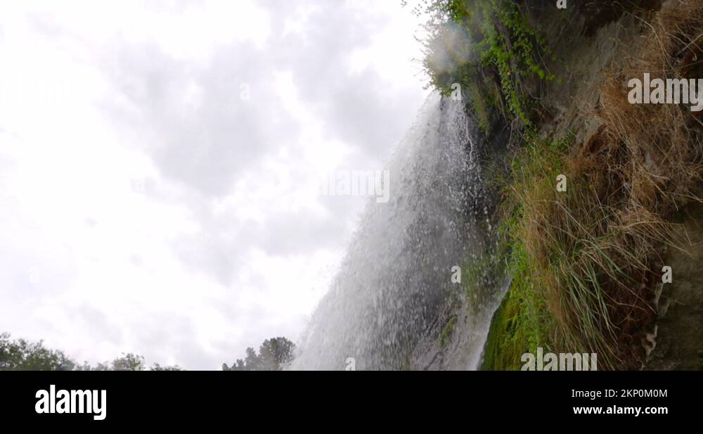a low angle rolling shot looking up from the base of a waterfall Stock ...