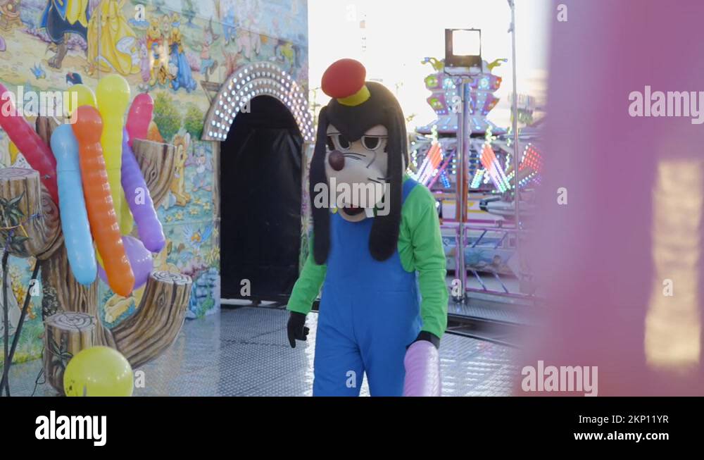 Tren chu chu attraction in a funfair in Valencia. Man in Goofy costumes ...