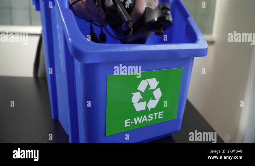 E-Waste Recycling Old Electronic Devices in a Blue Bin at Home Stock ...