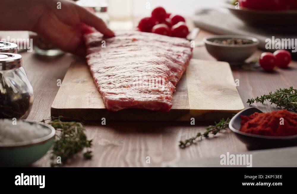 Woman chef cooking ribs close-up. Professional cheif preparing pork ...