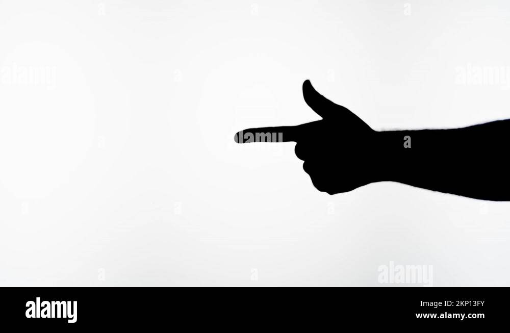 Shadow of hand showing gun with fingers on white background. Man shows ...