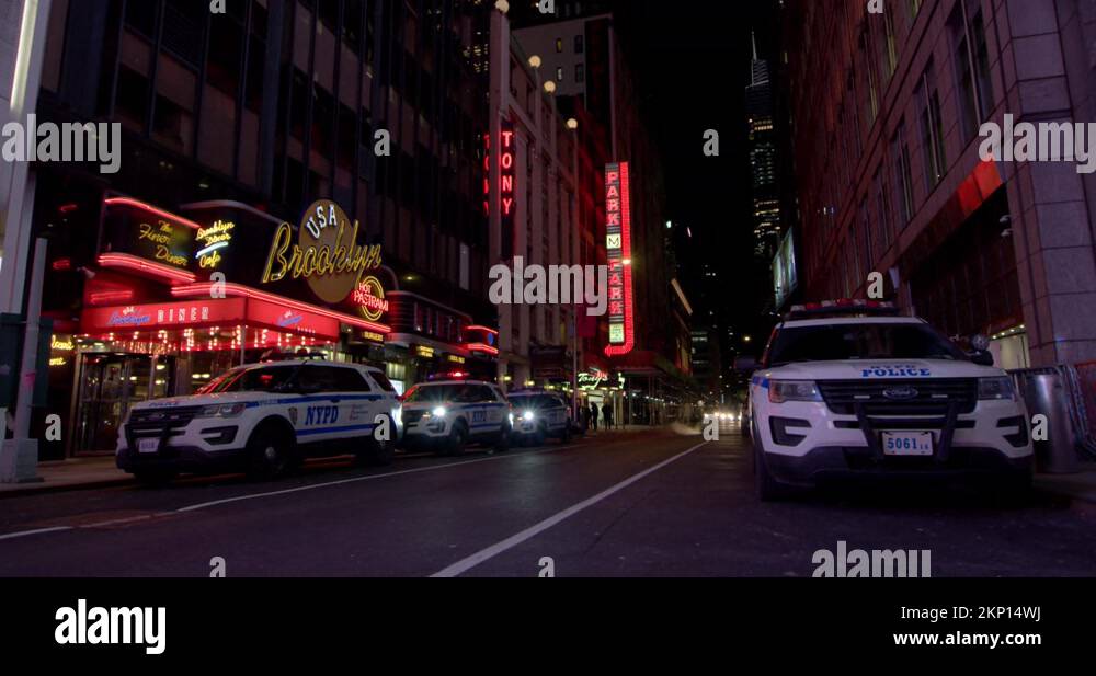 Times Square walking people drive police cars lit billboards, a lot of ...