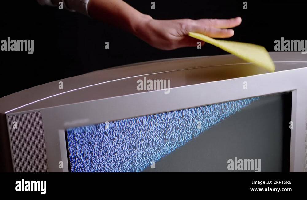 Female Hand Wipes Dust with a Yellow Rag from Surface of an Old TV in ...