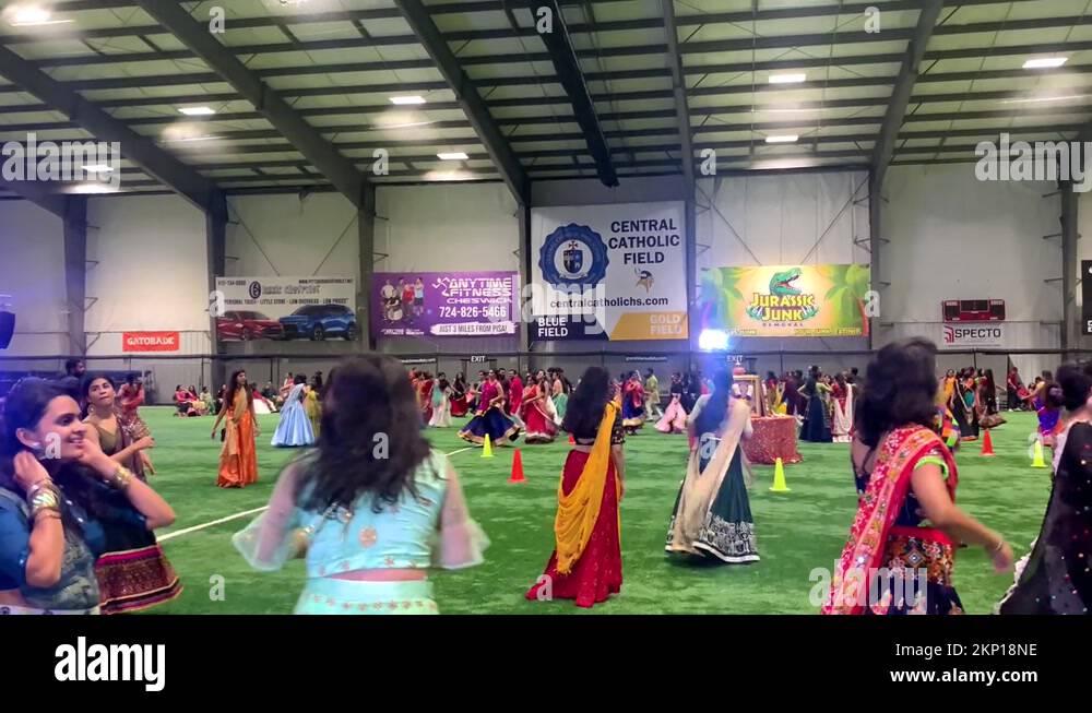 Group of Indian men and women playing Garba in traditional clothing ...