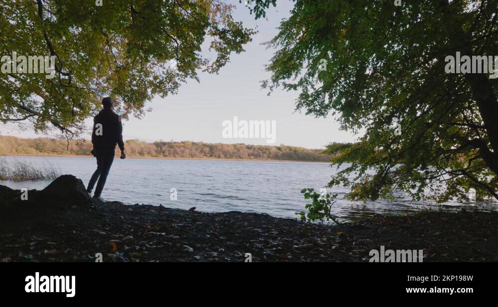Tall Guy With Cap Walks and Observes The Trees and The Lake of Gyllebo ...