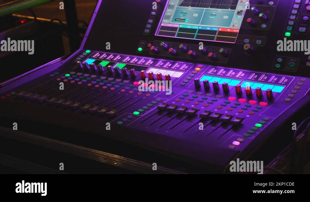Modern digital mixing console with faders, control buttons and screen ...