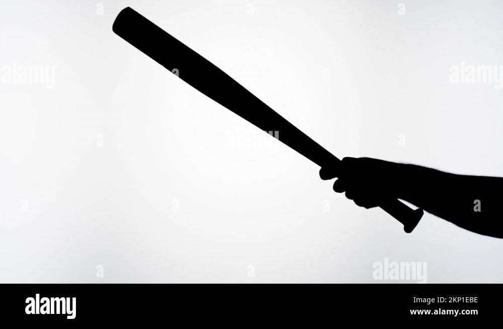 Man holding baseball bat close-up, shadow silhouette of hand with ...