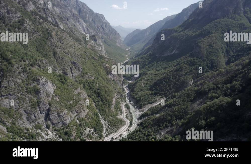 Drone video of frontal descending plane between the hills of the ...