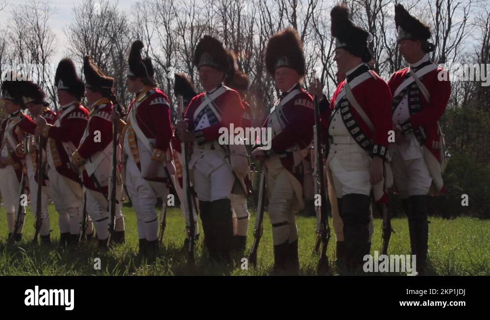 British Redcoat Re-enactor Grenadiers stand with flintlock muskets in ...