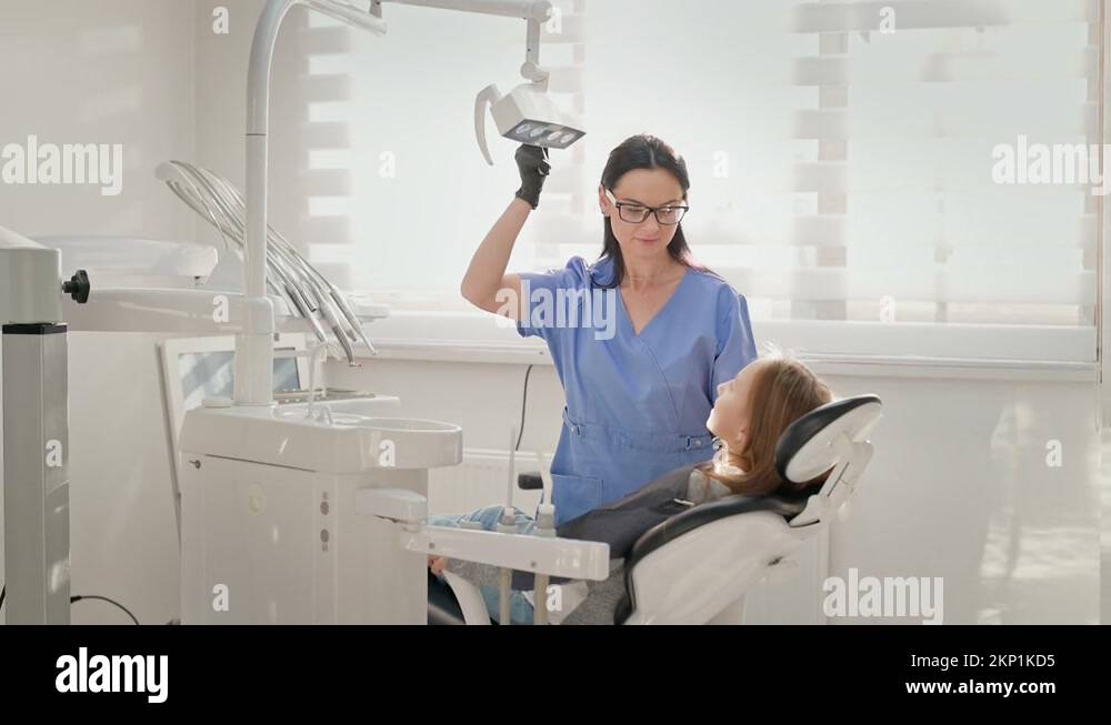 Little Girl At Dentists Office. Young Female Dentist Directs Light On Girls Face Stock Video ...